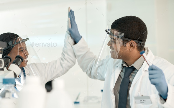 Shot of two scientists giving each other a high five while working ...