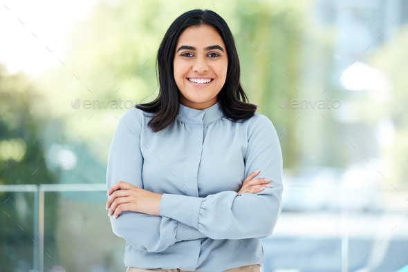 Cropped portrait of an attractive young businesswoman standing with her arms folded in the ...