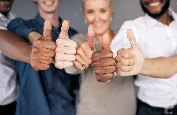Shot of a group of workers showing a thumbs up in a office Stock Photo ...