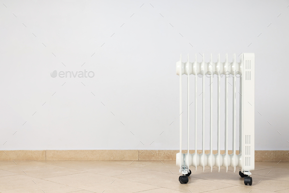 Concept of heating season, modern electric heater in room Stock Photo ...