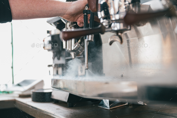 Coffee machine in steam, barista preparing coffee at cafe Stock Photo ...