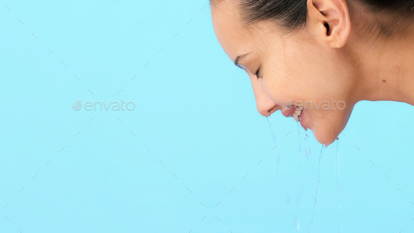 Young cheerful girl with water running down her face. Woman washing her ...