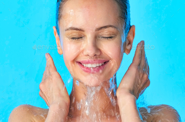 Woman washing her clean face with water. Closeup face of an Young girl ...