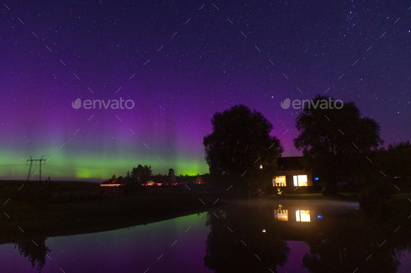 Night landscape with northern lights in green violet starry sky Stock ...