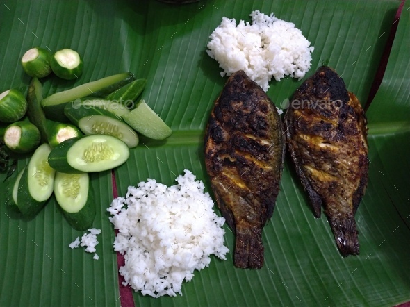 Tilapia grilled with rice,served with banana leaves Stock Photo by ...