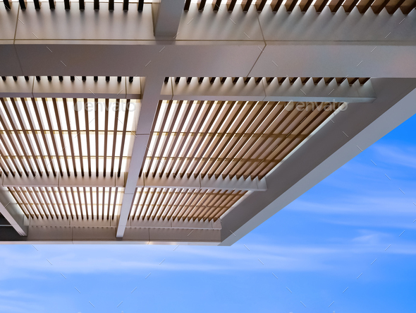 Modern battens roof awning outside of building against blue sky ...