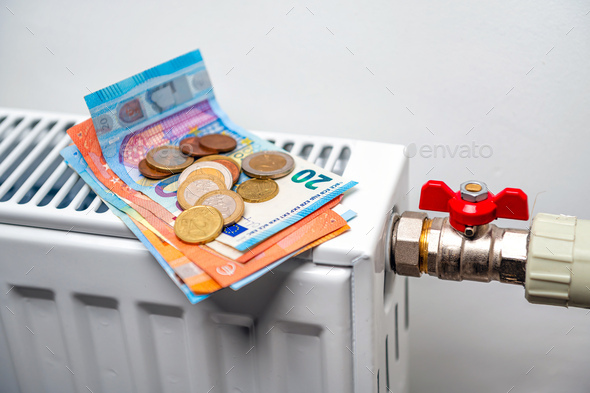 euro banknotes in a central heating radiator, the concept of expensive ...