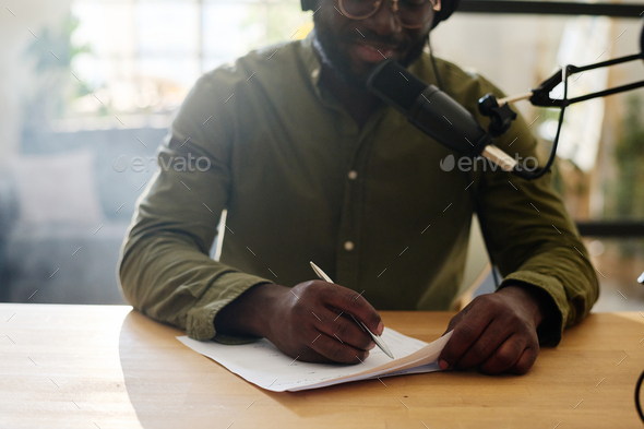 Close-up of young black man pointing at paper with questions for ...