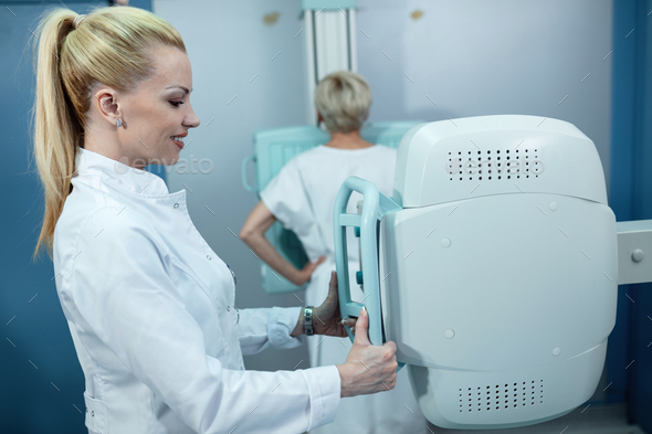 Smiling radiologist during X-ray procedure in the hospital. Stock Photo ...