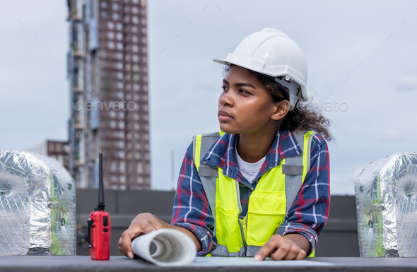 Engineers with draft plan of building on constructing site. Engineer ...