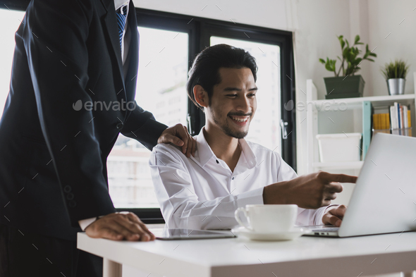 manager show thumb up and admire to worker after seeing profit ...