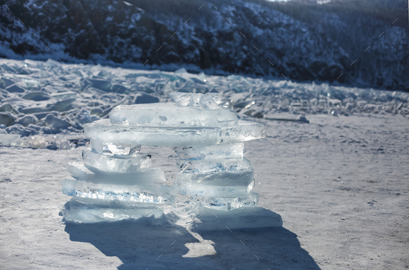 Pieces of ice lying on the ideal smooth ice of baikal with ice hummocks ...