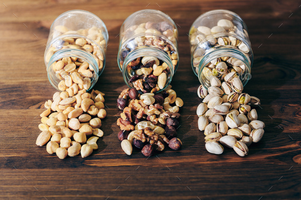 three glass jars with varied nuts and dried fruits Stock Photo by Raul ...
