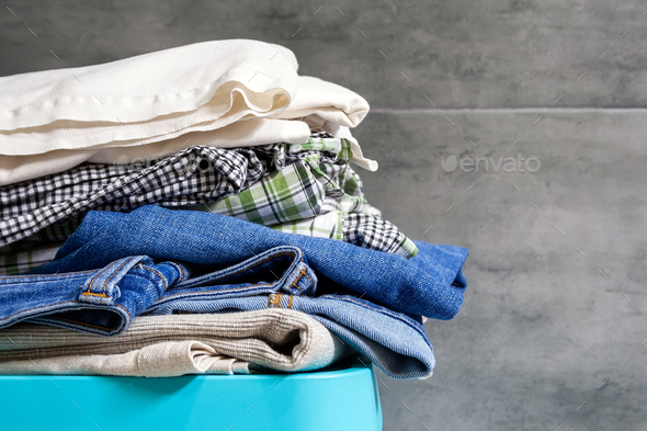 Pile of laundry and clothes prepared for washing Stock Photo by Bykfa
