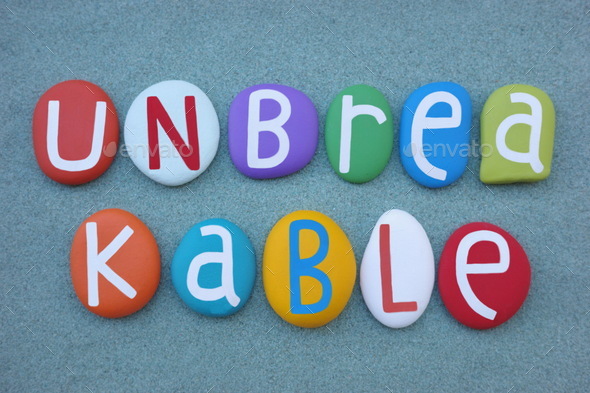 Unbreakable, creative text composed with multi colored stone letters ...