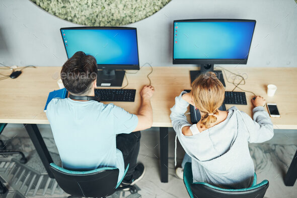 Students learning in computer classroom. Focused students studying for ...