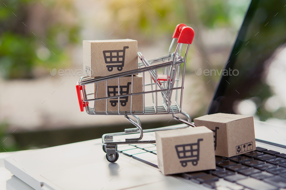 Shopping online. Cardboard box with a shopping cart logo in a trolley ...