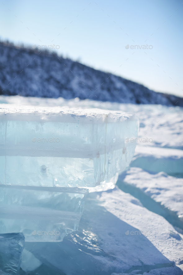 Pieces of ice lying on the ideal smooth ice of baikal with ice hummocks ...