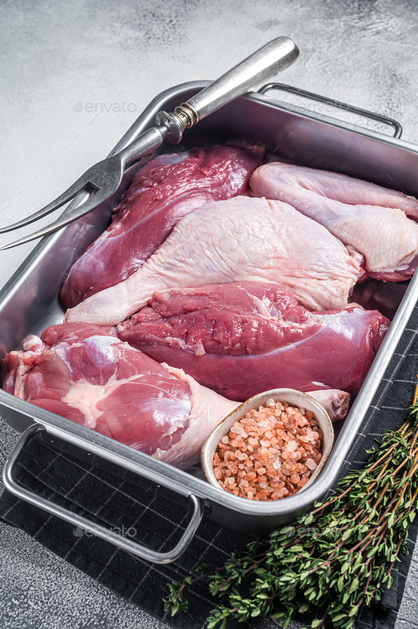 Raw duck parts, fresh breast fillet, legs, wings in a kitchen tray ...