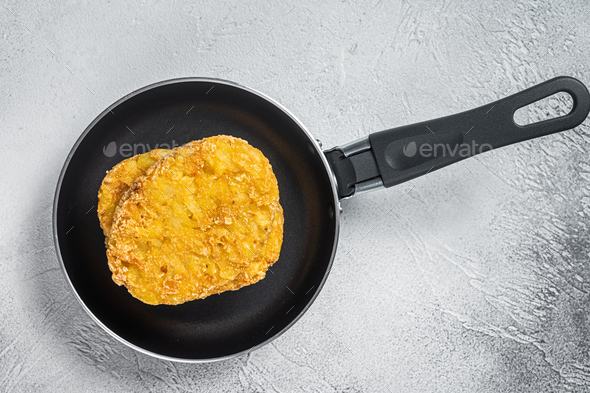 Fried Hash brown potato, hashbrown fritters in a skillet. White ...