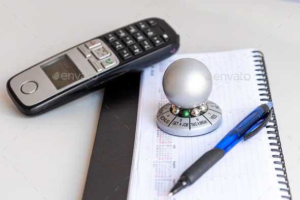 table with organizer, phone and wheel of opportunity, pointer on GET A ...