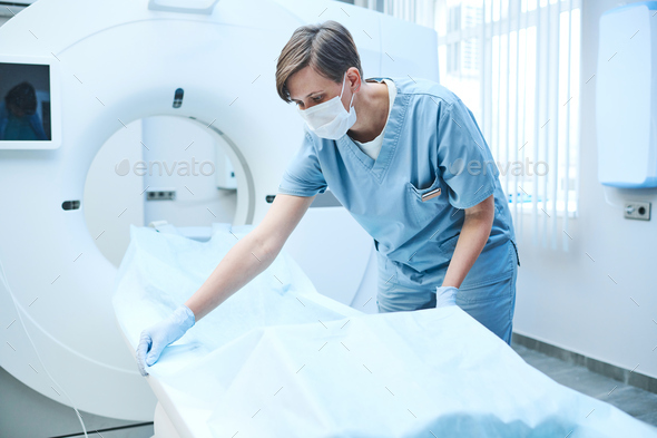 Preparing MRI scan table for patient Stock Photo by Media_photos ...