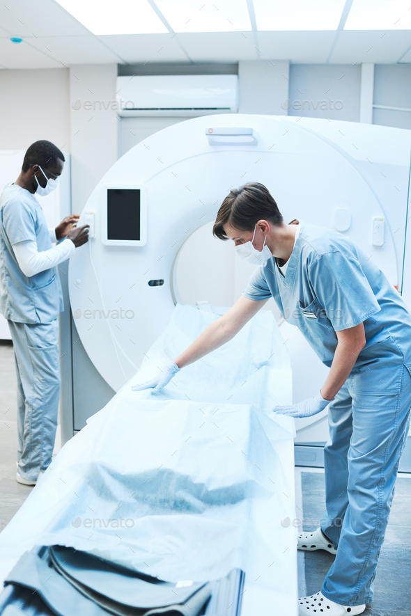Spreading out sheet on MRI scan table Stock Photo by Media_photos ...