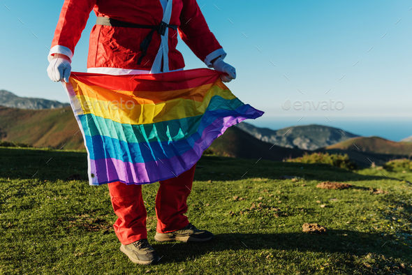 santa claus holding a rainbow lgbt pride Stock Photo by Meniphoto ...