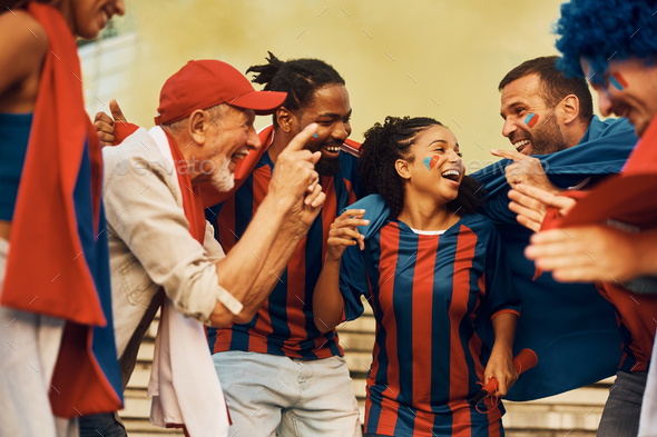Cheerful fans of the football team having fun while celebrating victory ...