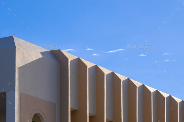 Side view of concrete wall fins sunshade on modern beige house against ...