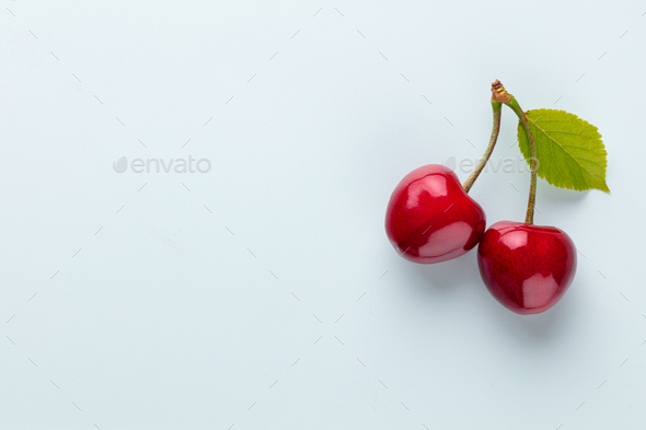Cherry berries on a pastel background top view. Background with a ...