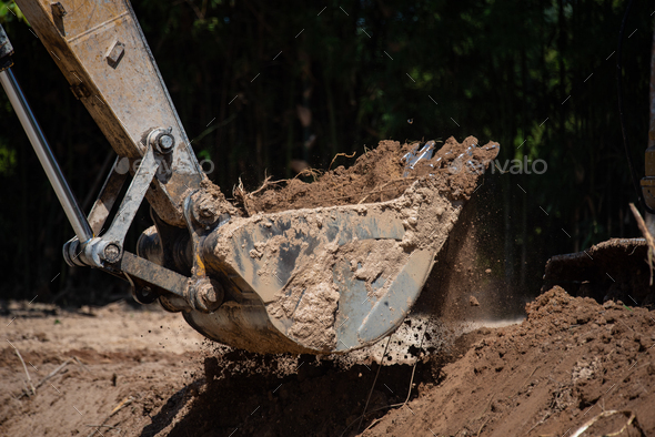 bulldozer machine digging the ground and removing sand for excavation ...