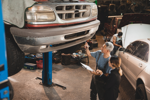 customer making inspection check to a car engine repair occupation job ...