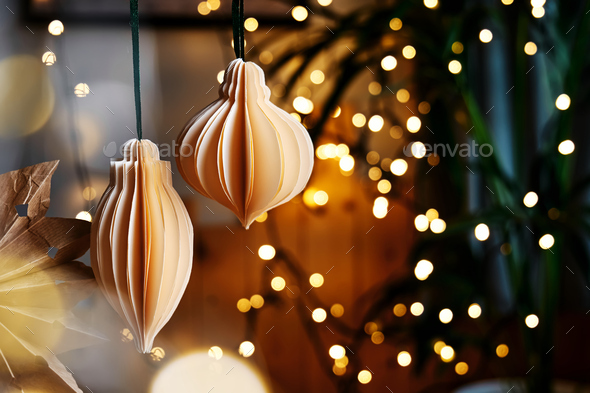 Handmade paper christmas decorations scandi style on branch on blurred ...