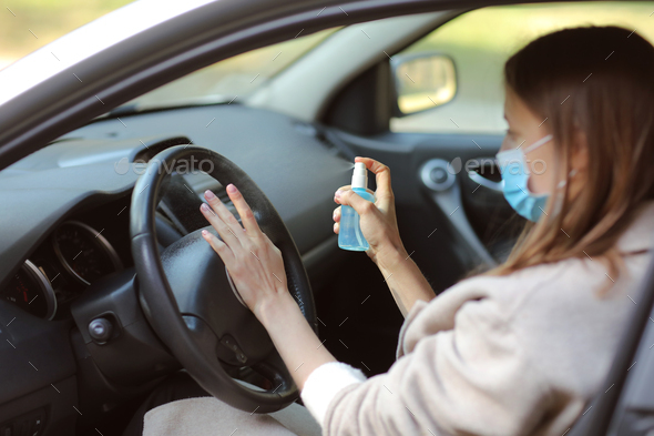 Spraying anti-bacterial sanitizer spray on hand in car, infection ...