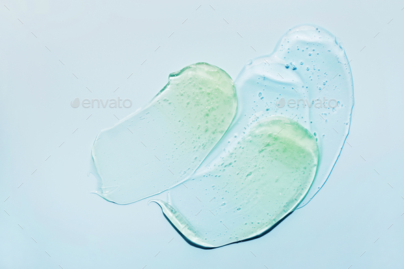 Liquid abstract cosmetic gel smears on blue background. Smear of ...