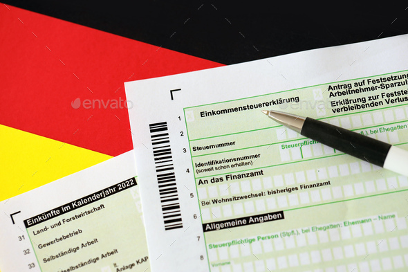 German annual income tax return declaration form with pen on flag close ...