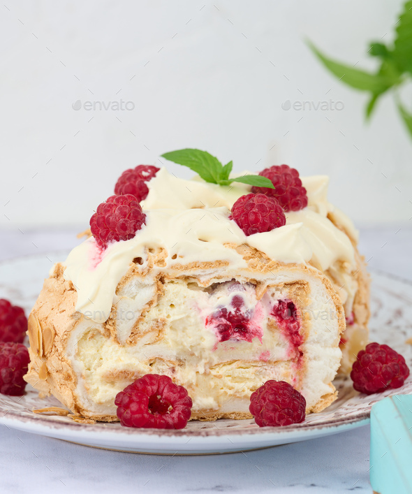 Baked meringue roll with cream and fresh red raspberry, white ...