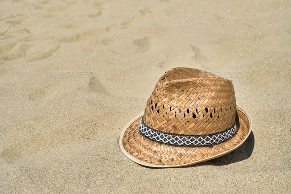 Men's straw beach hat on the sand at the beach, close-up Stock Photo by ...