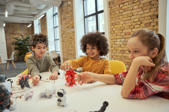 Making learning fun. Ambitious diverse kids having fun together while ...