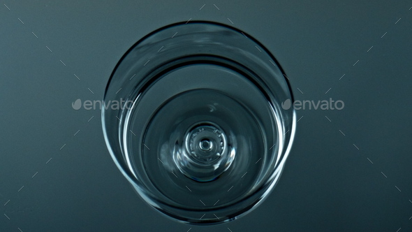 Water droplet falling cup top view. Pure liquid waving rippling in ...