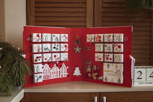 Pretty girl holds original advent calendar made of jewelry boxes and ...