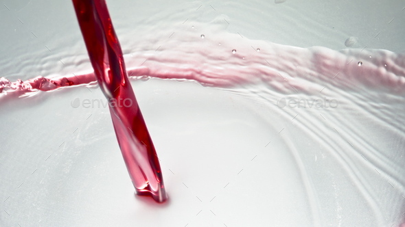 Intoxicant red beverage filling goblet. Pouring alcoholic liquid clean ...