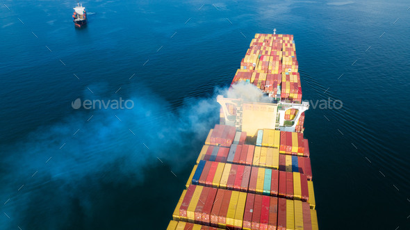 Stern of large cargo ship with Smoke exhaust gas emissions from cargo ...