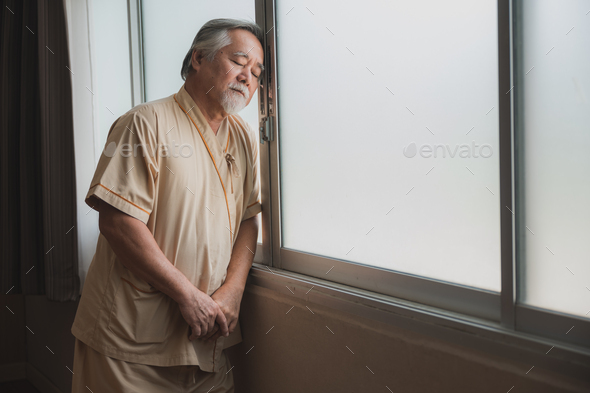 senior citizen stay at hospital, his face look worried about health ...