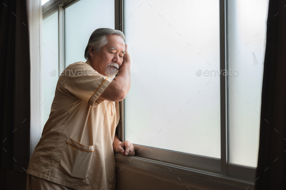 senior citizen stay at hospital, his face look worried about health ...
