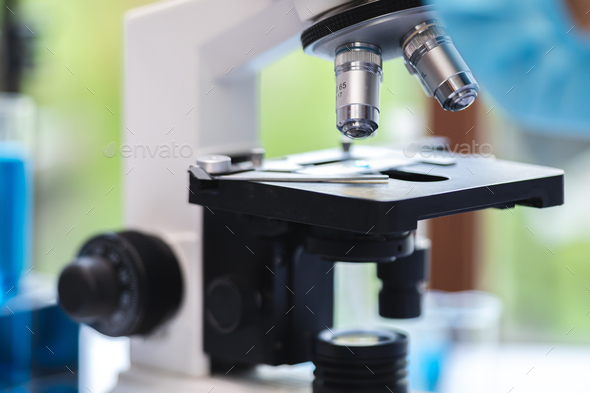 professional research scientist using microscope in science chemistry ...
