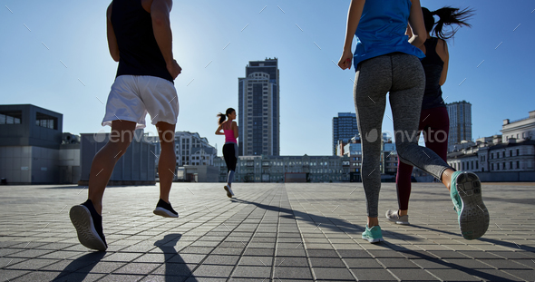 Company of young people running on cityscape background Stock Photo by ...