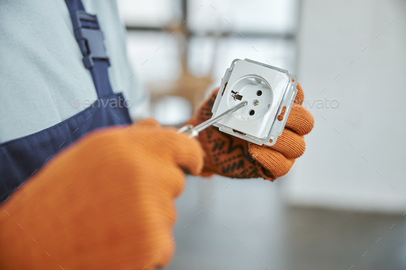 Male electrician hands fixing electrical wall socket Stock Photo by ...