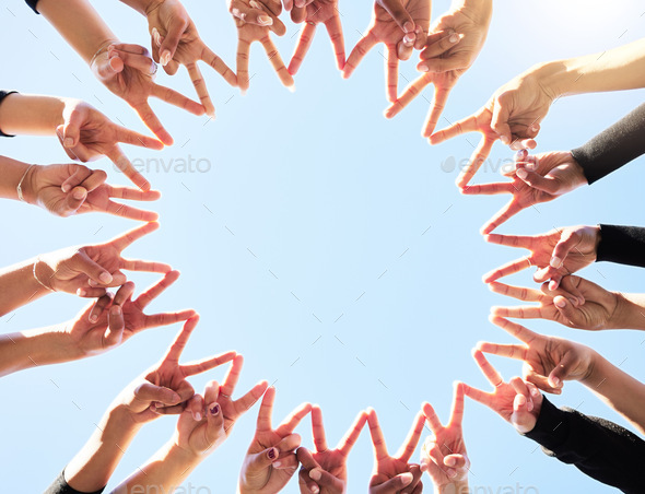 Shot of a group of people forming star shapes with their hands in a ...